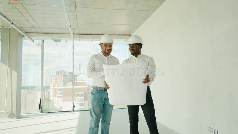 Indian Architect and African Supervisor Walking at Construction Site ...