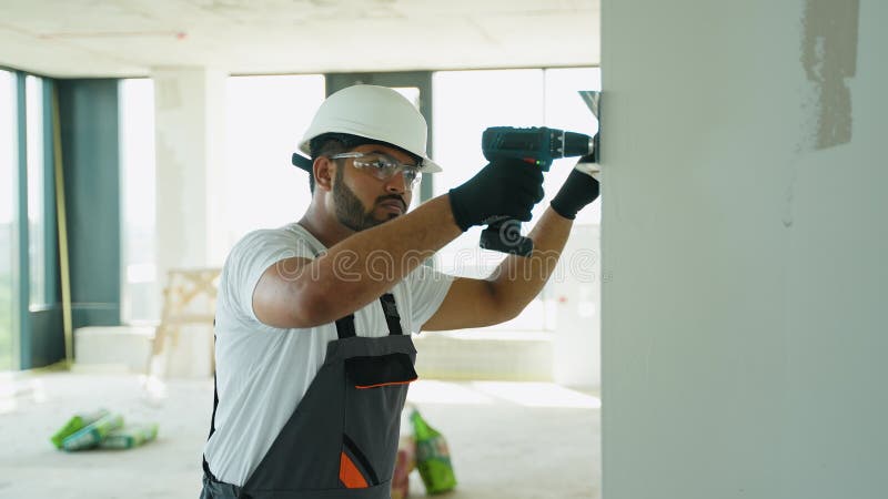 Indian Builder Installing Drywall with Power Drill on Site Stock ...