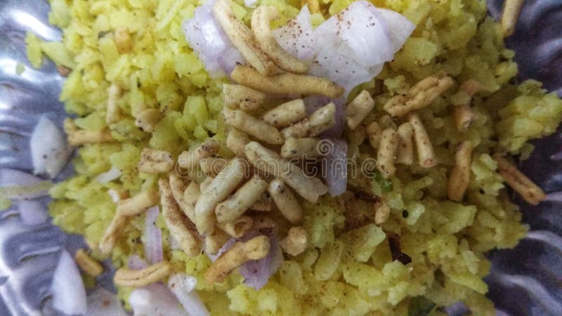 Indian Breakfast Poha Garnished with Sev and Onions Stock Photo - Image ...