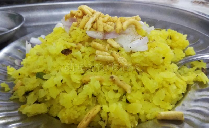 Indian Breakfast Poha Garnished with Sev and Onions Stock Photo - Image ...