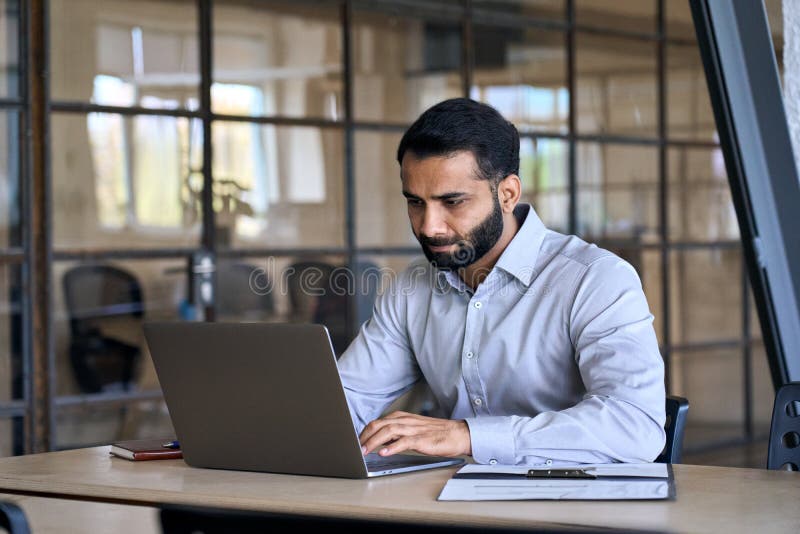Indian Business Man Using Computer Working in Office Doing Online Data ...