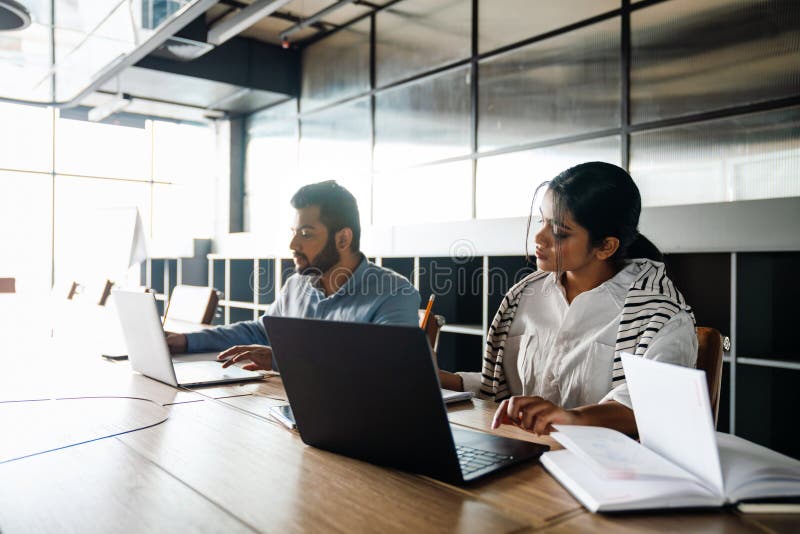 Indian Business People Working on Laptops while Sitting in Office Stock ...