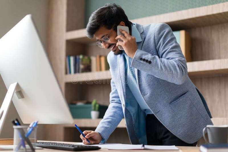 Indian Businessman in Conversation Over Phone Taking Notes in Office ...