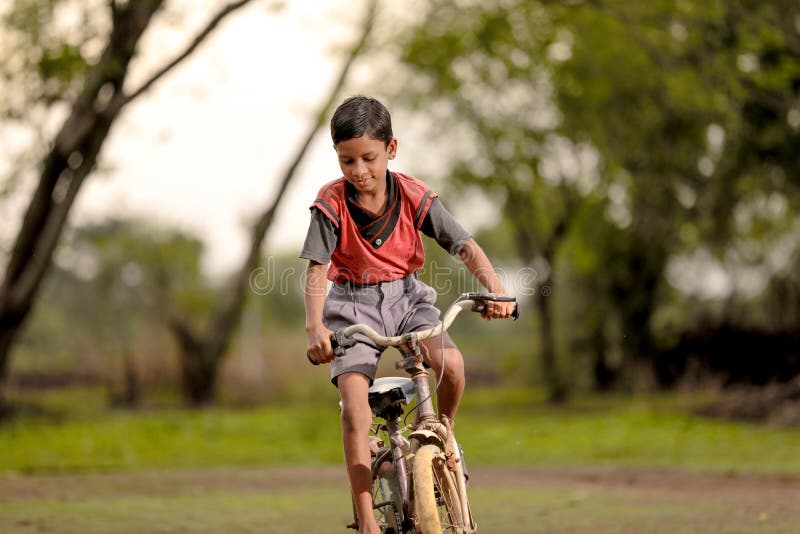 Indian child on bicycle stock photo. Image of play, childhood - 133129464
