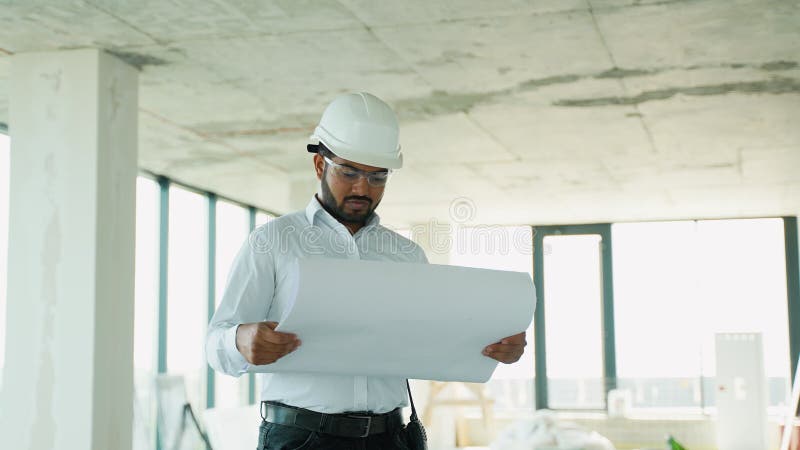 Indian Civil Engineer Analyzing Construction Blueprints at Building ...