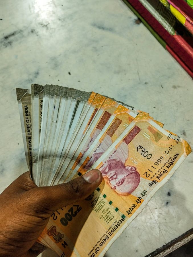 Indian Currency with Hand in Two Hundred Rupees Stock Image - Image of ...