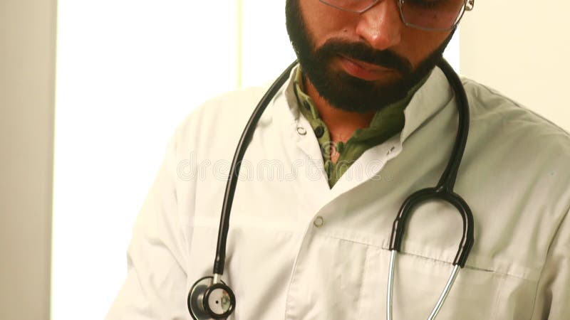 Indian Doctor Wearing Uniform Taking Notes in Medical Documents Stock ...