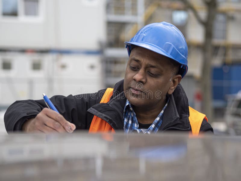 Indian Engineer at Work Writing Outdoors Stock Photo - Image of ...