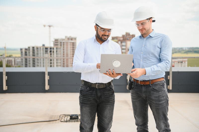 Indian and European Construction Workers Together at a Construction ...