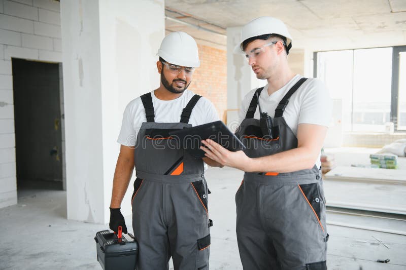 Indian and European Construction Workers Together at a Construction ...