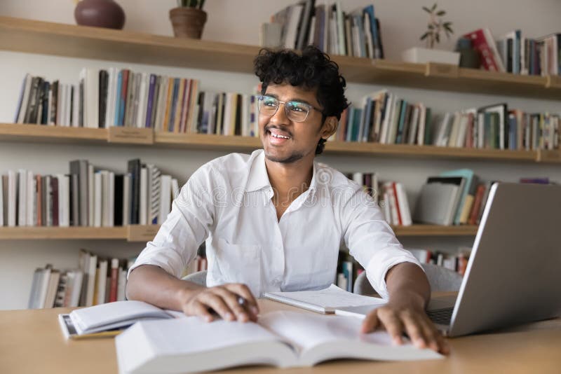 Indian Guy Studying Looks into Distance with Contented Smile Stock ...