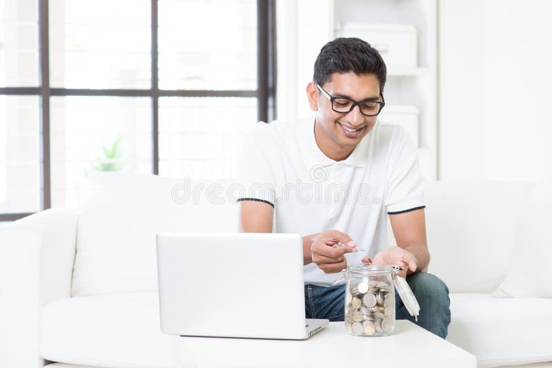 Indian Guy Using Computer and Counting Money at Home Stock Image ...