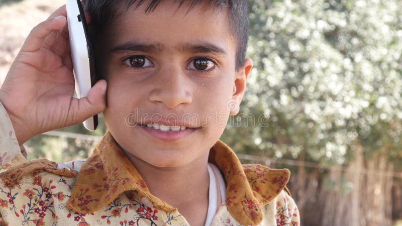 Indian Kid Talking on the Phone and Smiling Stock Image - Image of ...