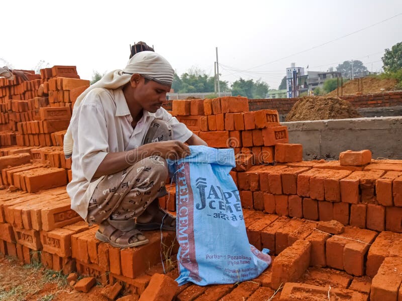 An Indian Labour Putting Bricks Inside Tha Sack at Construction Site in ...