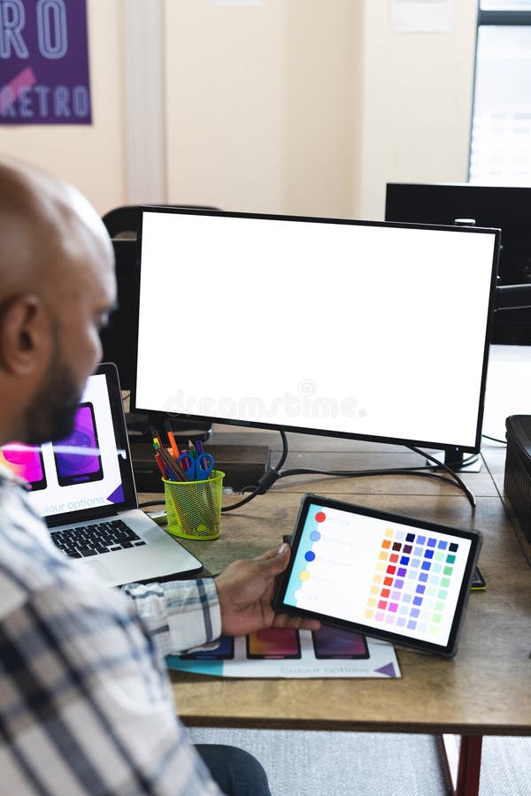 Indian Male Designer Using Tablet and Computer with Copy Space at Desk ...