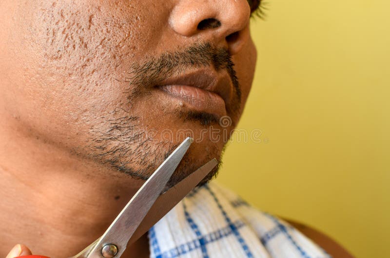 An Indian Male Grooming and Beautifying His Beard and Mustache with a ...