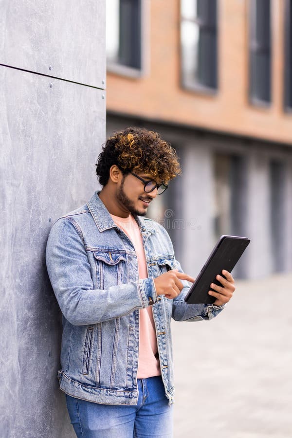 Young Indian Male Using Tablet Outdoor on the Street Stock Photo ...
