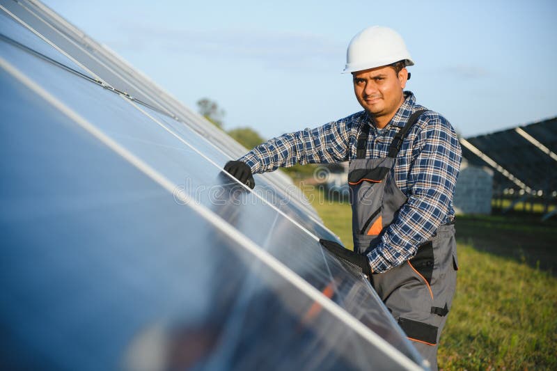 An Indian Male Worker is Working on Installing Solar Panels in a Field ...