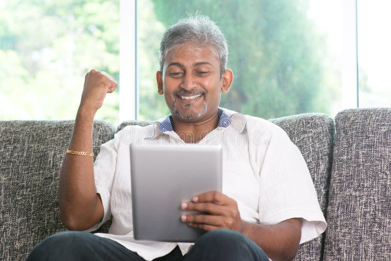Indian Man Cheering while Using Tablet Pc Stock Photo - Image of ...