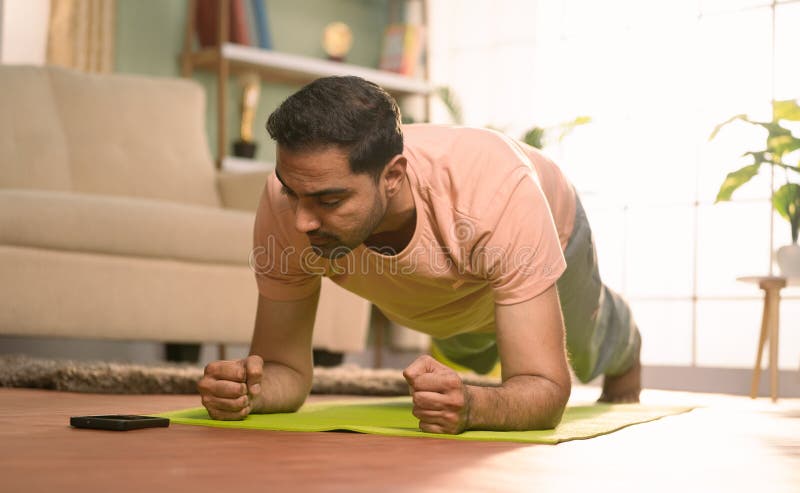 Indian Man Doing Plank Workout or Exercise for Abs by Setting Timer on ...