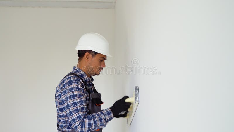 Indian Man Drywall Worker or Plasterer Putting Plaster on Plasterboard ...