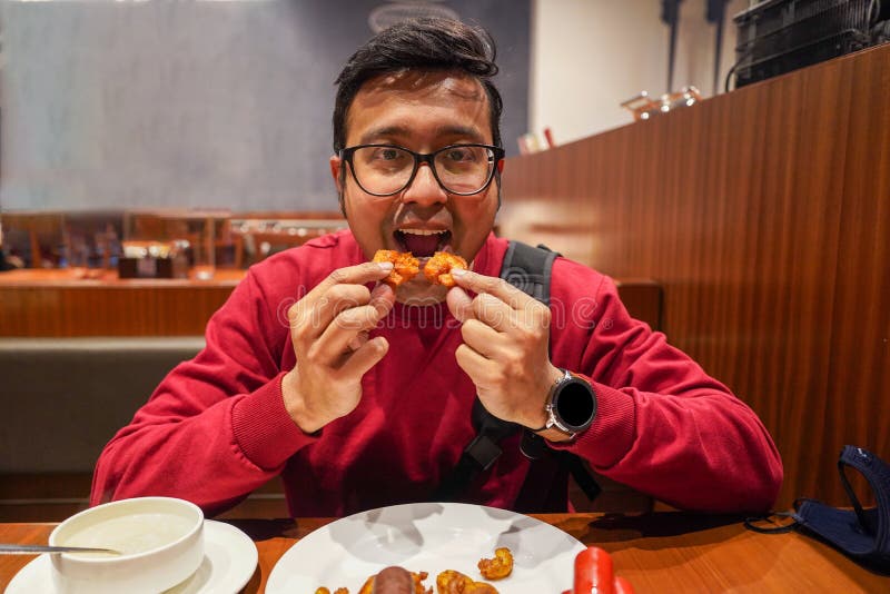 Indian Man Eating Chicken Wings at a Cafe Stock Photo - Image of dinner ...