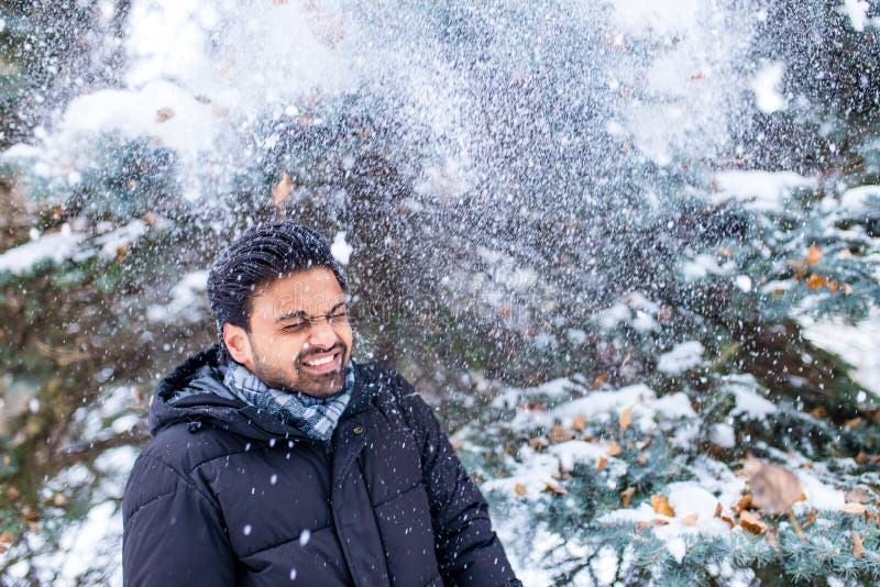 Indian Man Enjoying Snowflakes Falling from Upwards in Forest Stock ...