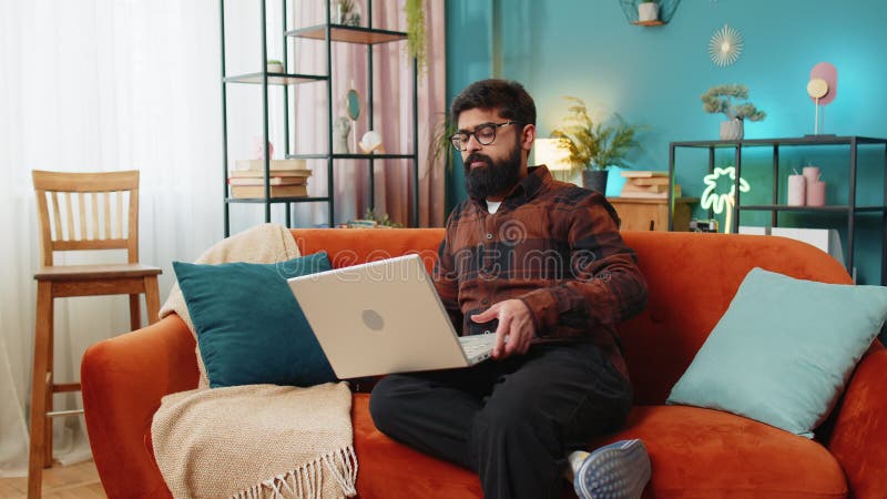Happy Young Indian Man Typing Working on Laptop Browsing Internet Using ...