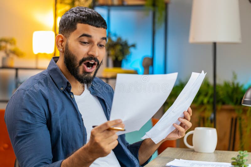 Indian Man Freelancer Working with Documents from Home Office Analyzing ...