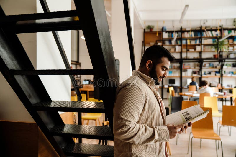 Indian Man Reading Book while Standing in Library Stock Image - Image ...