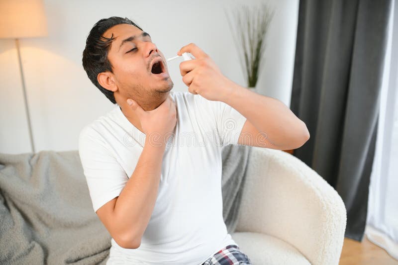 Indian Man Sick at Home, Cold, Flu. a Man Uses a Throat Spray Stock ...
