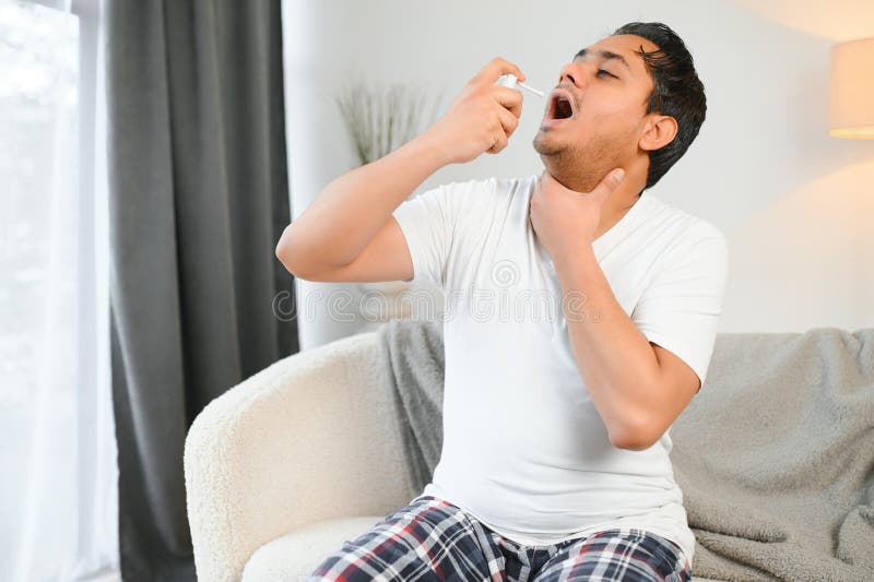 Indian Man Sick at Home, Cold, Flu. a Man Uses a Throat Spray Stock ...