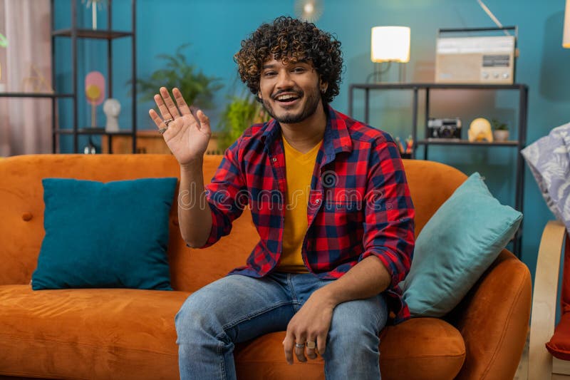 Indian Man Smiling Friendly at Camera, Waving Hands Gesturing Hello, Hi ... Indian Man Smiling Friendly at Camera, Waving Hands Gesturing Hello, Hi ...
