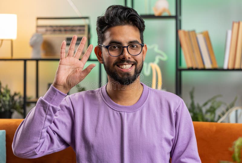 Indian Man Smiling Friendly at Camera, Waving Hands Gesturing Hello, Hi ... Indian Man Smiling Friendly at Camera, Waving Hands Gesturing Hello, Hi ...