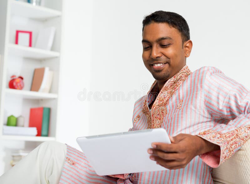 Indian Man Using Digital Tablet at Home. Stock Image - Image of online ...