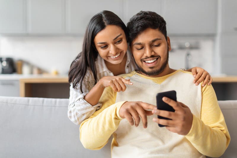 Indian Man and Woman Looking at Cell Phone Stock Photo - Image of ...