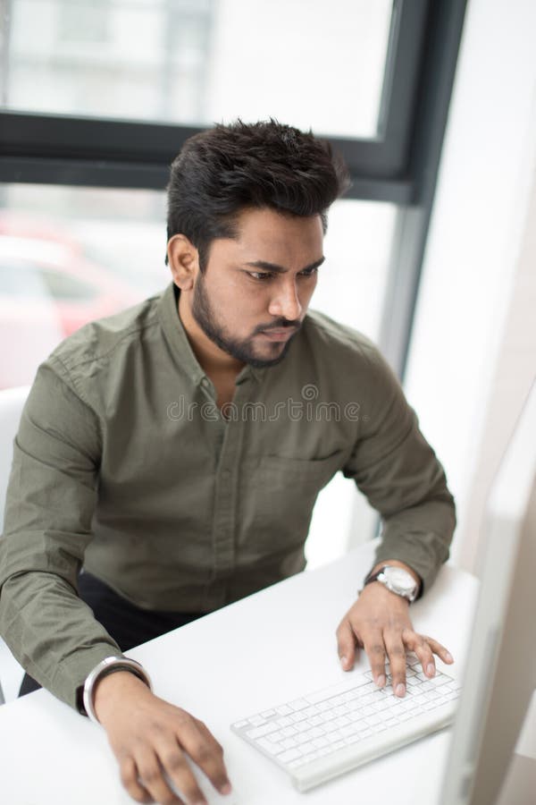 Indian Man Working at Computer from Modern Bright Office Stock Image ...