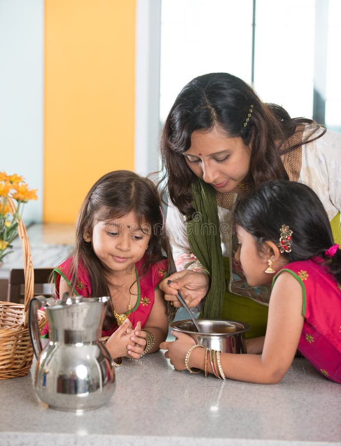 Indian Mother Cooking with Her Daughters Stock Photo - Image of ...