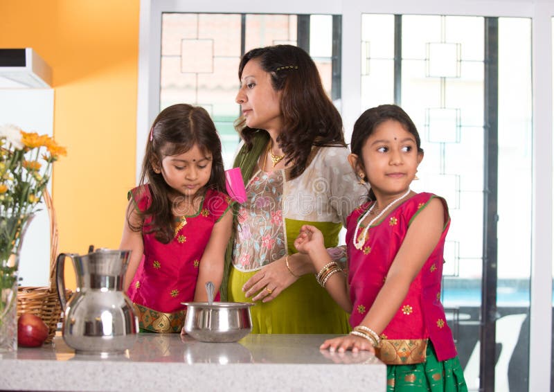 Indian Mother Cooking with Her Daughters Stock Photo - Image of ...