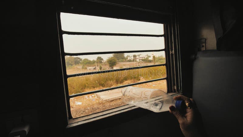 Indian People Throw a Plastic Bottle and Garbage from the Train Window ...
