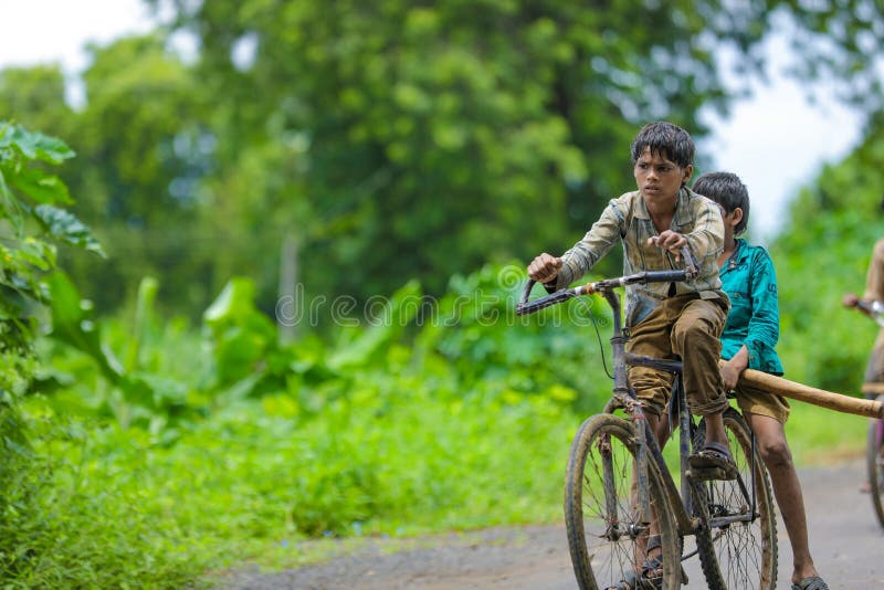Indian poor child on cycle editorial photography. Image of joyride ...
