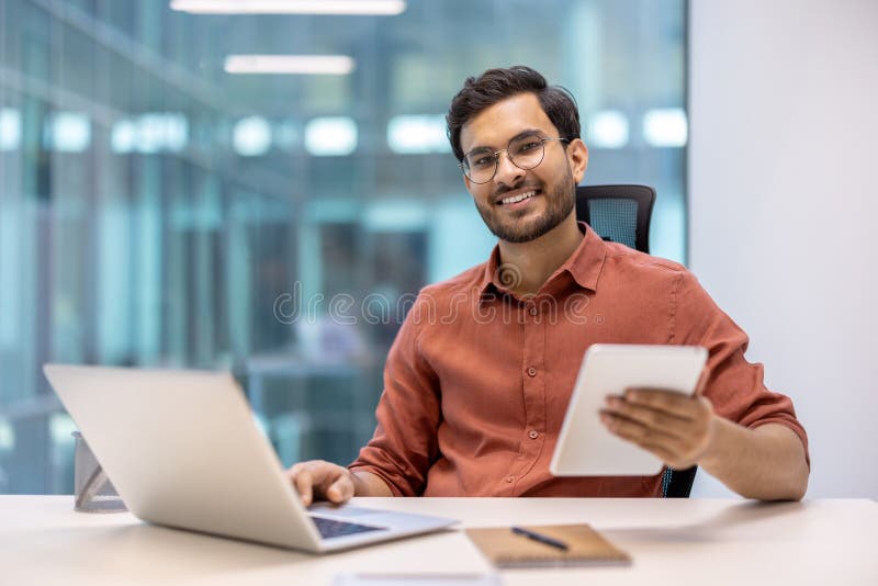 Indian Programmer Working with Laptop and Tablet in Modern Office Stock ...