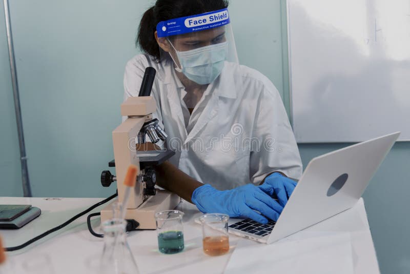 Indian Scientist Man Looking Microscope Using Laptop Analyze Research ...