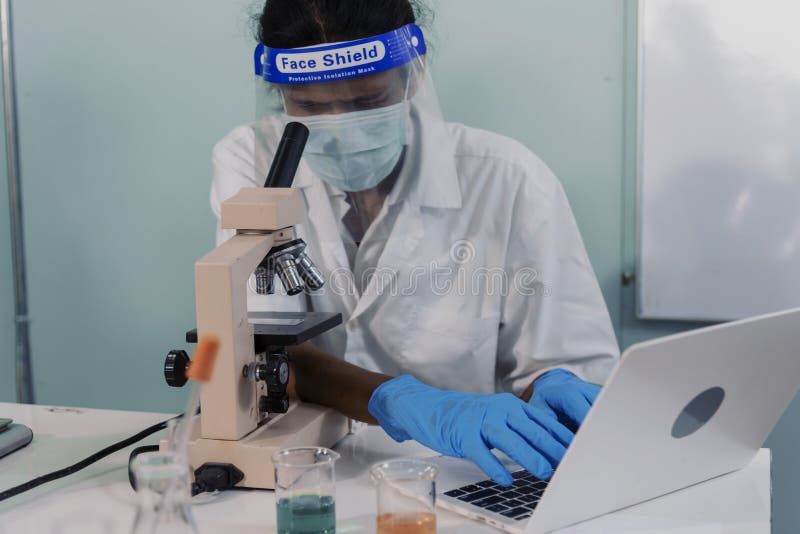Indian Scientist Man Looking Microscope Using Laptop Analyze Research ...