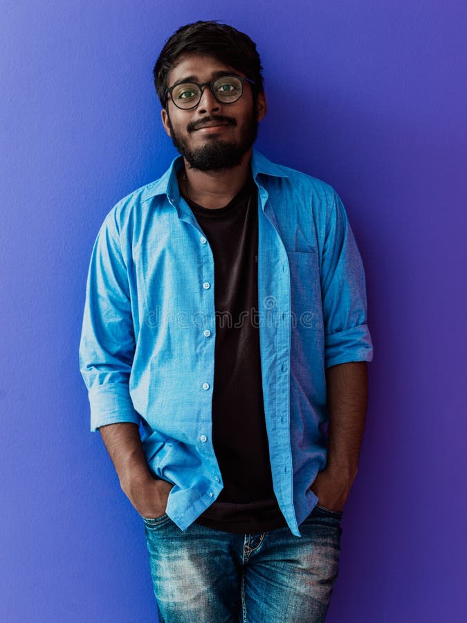 Indian Student with Blue Backpack, Glasses and Notebook Posing on Green ...