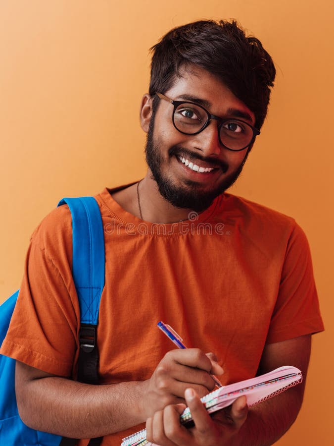 Indian Student with Blue Backpack, Glasses and Notebook Posing on ...
