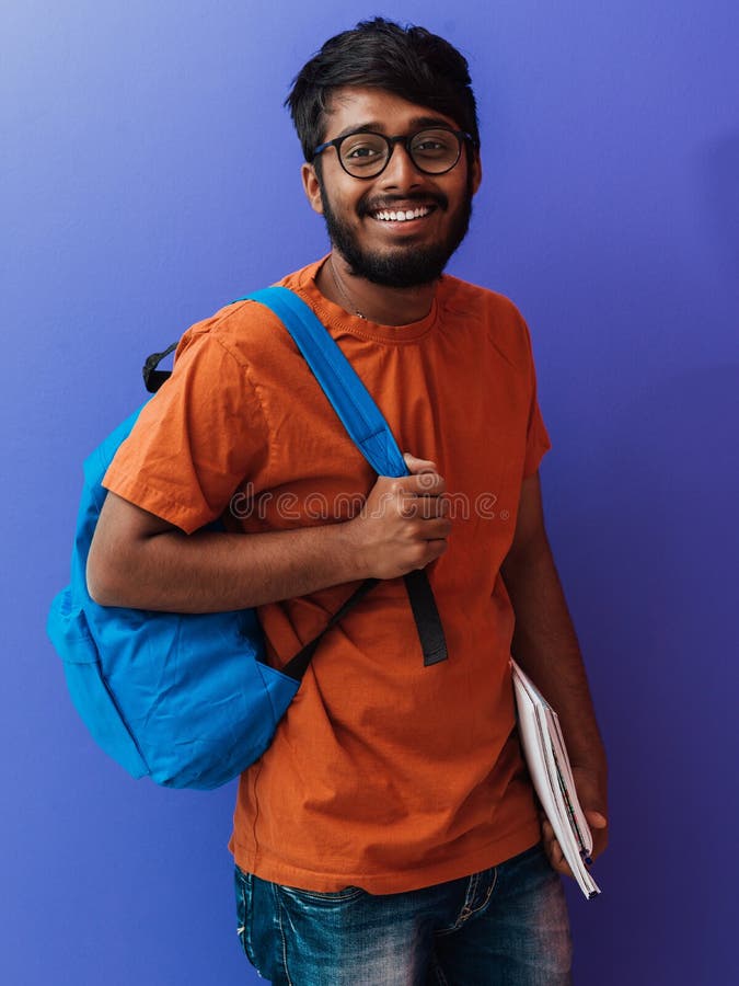 Indian Student with Blue Backpack, Glasses and Notebook Posing on ...