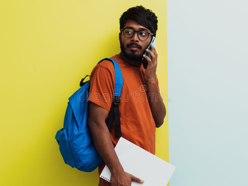 Indian Student with Blue Backpack, Glasses and Notebook Posing on ...