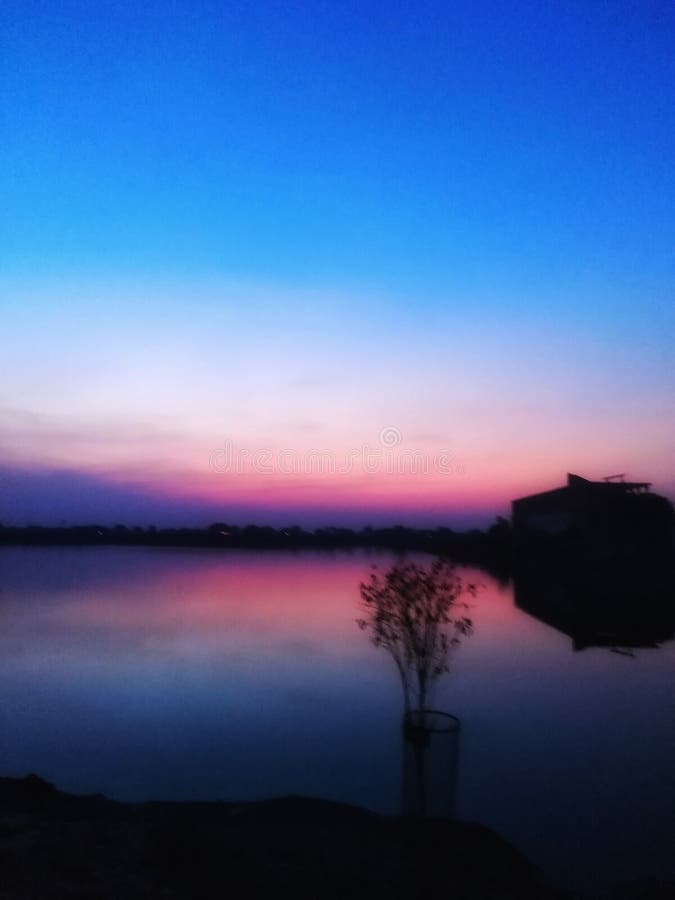 Indian sunset seen stock photo. Image of reflection - 210220264