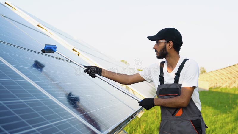 Cleaning Solar Panels.Man Washing Solar Panels from Dust and Dirt on ...